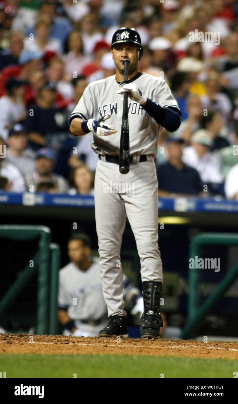 New York's Derek Jeter balances the bat as he approaches the plate ...