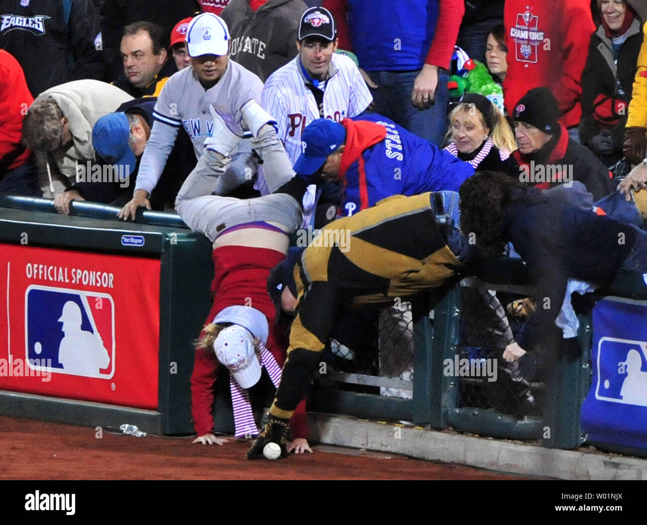 Fans battle for a foul ball during game 4 of the World Series between ...