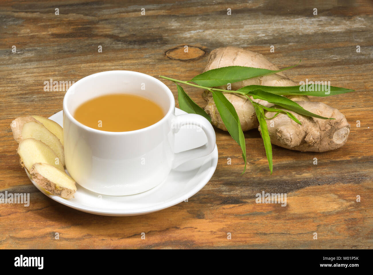 Ginger tea and cut ginger slices on table Stock Photo - Alamy