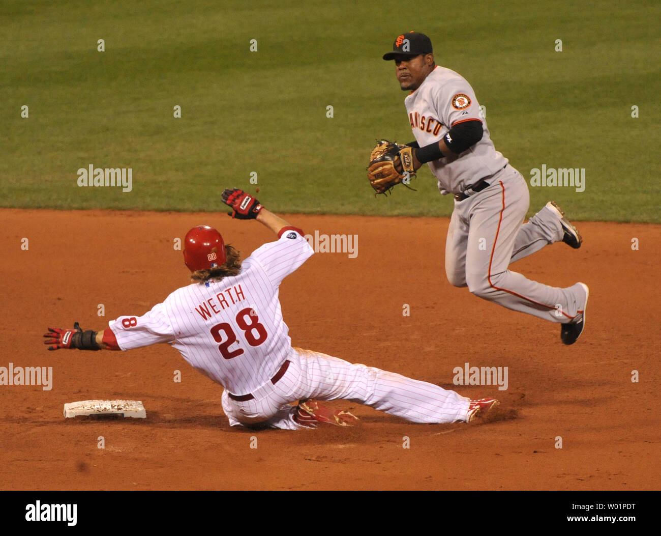San Francisco Giants' shortstop Juan Uribe goes air born as he makes ...