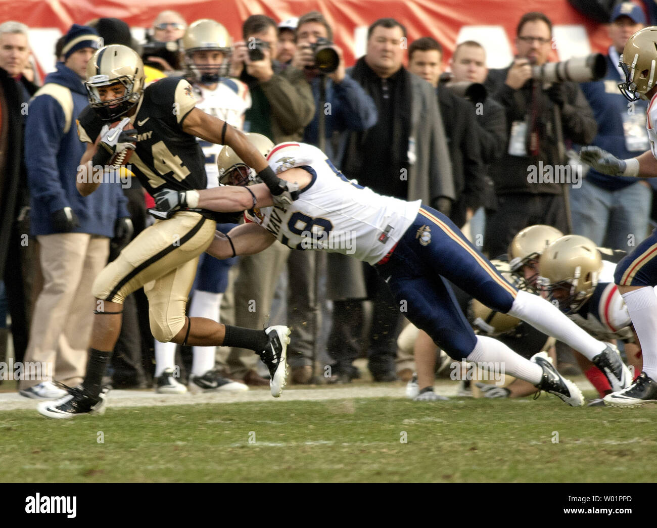 Army's Josh Jackson (14) gains yardage before being pulled down on the ...