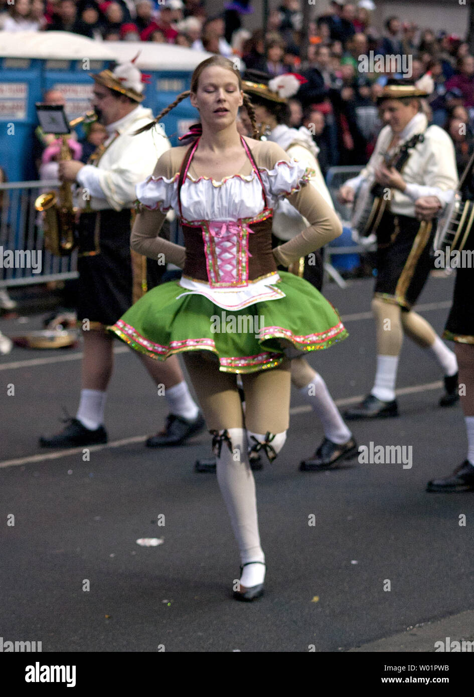 A member of the Trilby String Band dressed as a Swiss Alps maiden does ...
