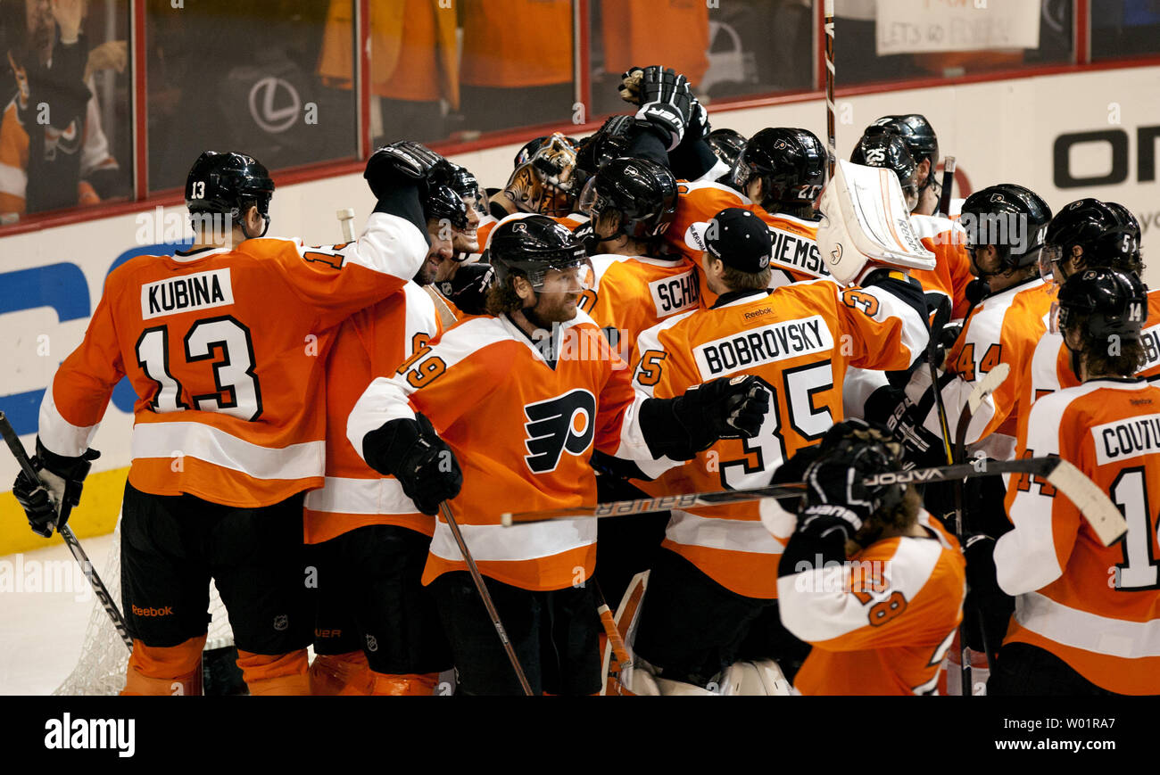 Philadelphia Flyers gather around goalie Srgei Bobrovsky after they ...
