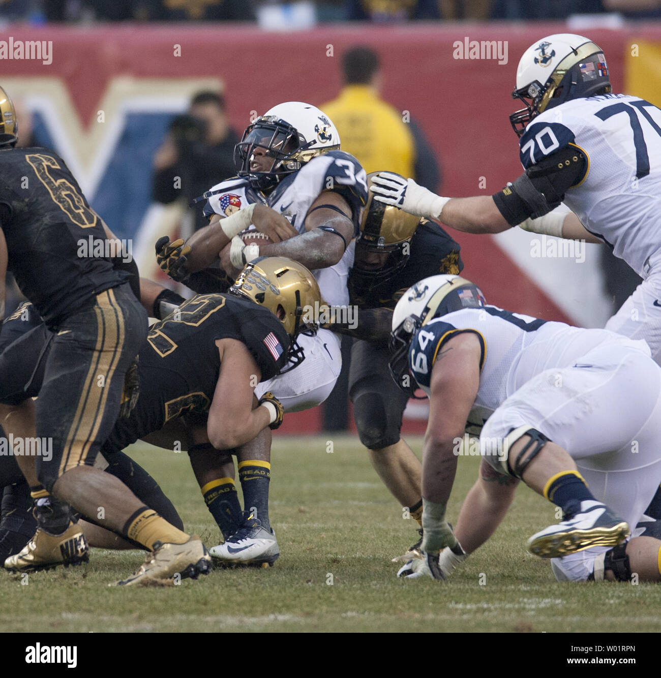 Navy fullback Noah Copeland (#34) is tackled by Army Nate Combs (22 ...