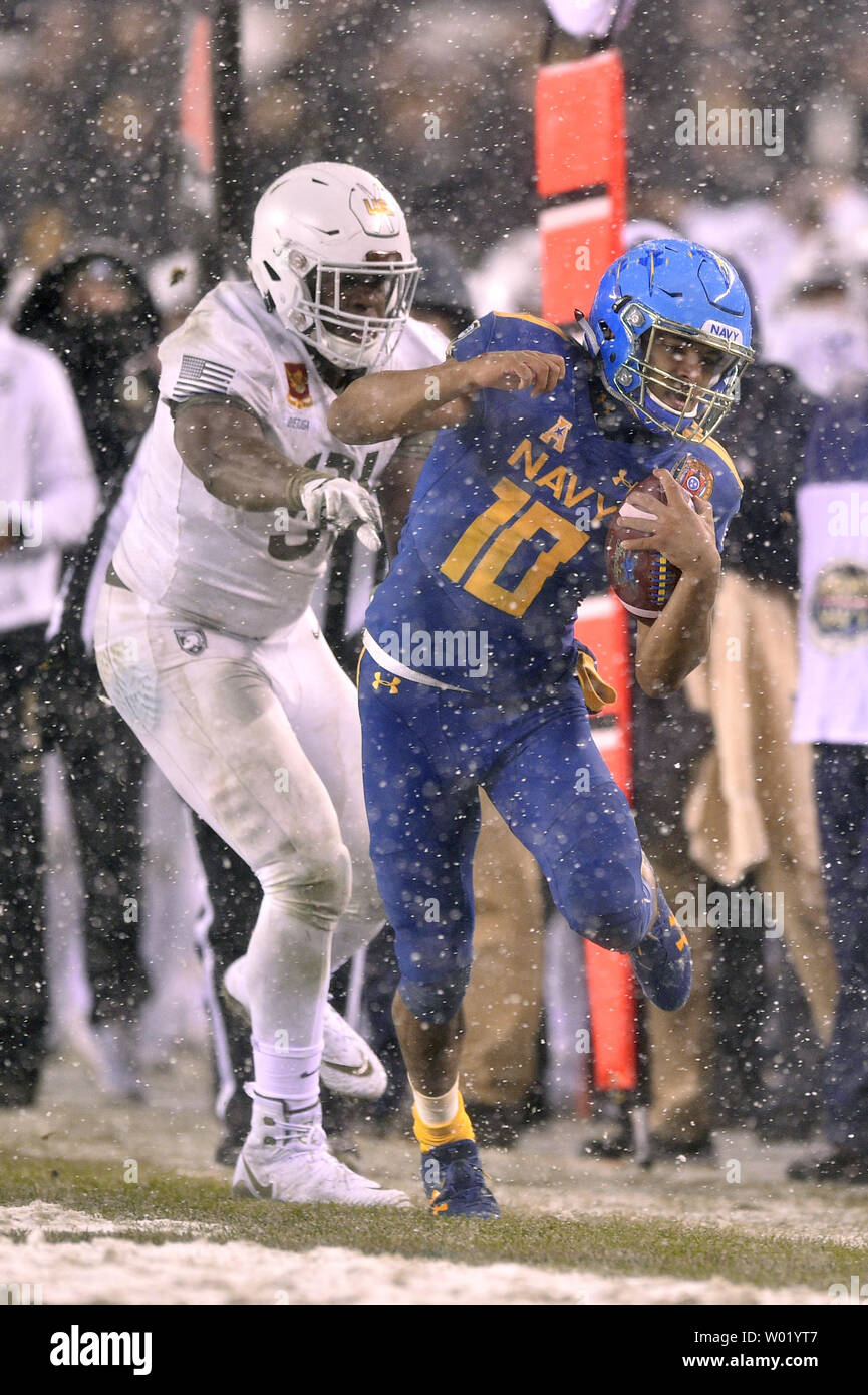 Navy Midshipmen running back Malcolm Perry (10) is pushed out of bounds ...