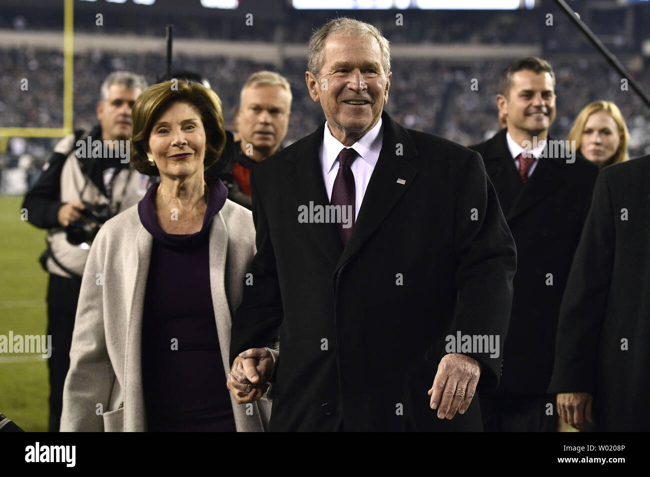 Former president George Bush walks to the sidelines prior to an NFL ...
