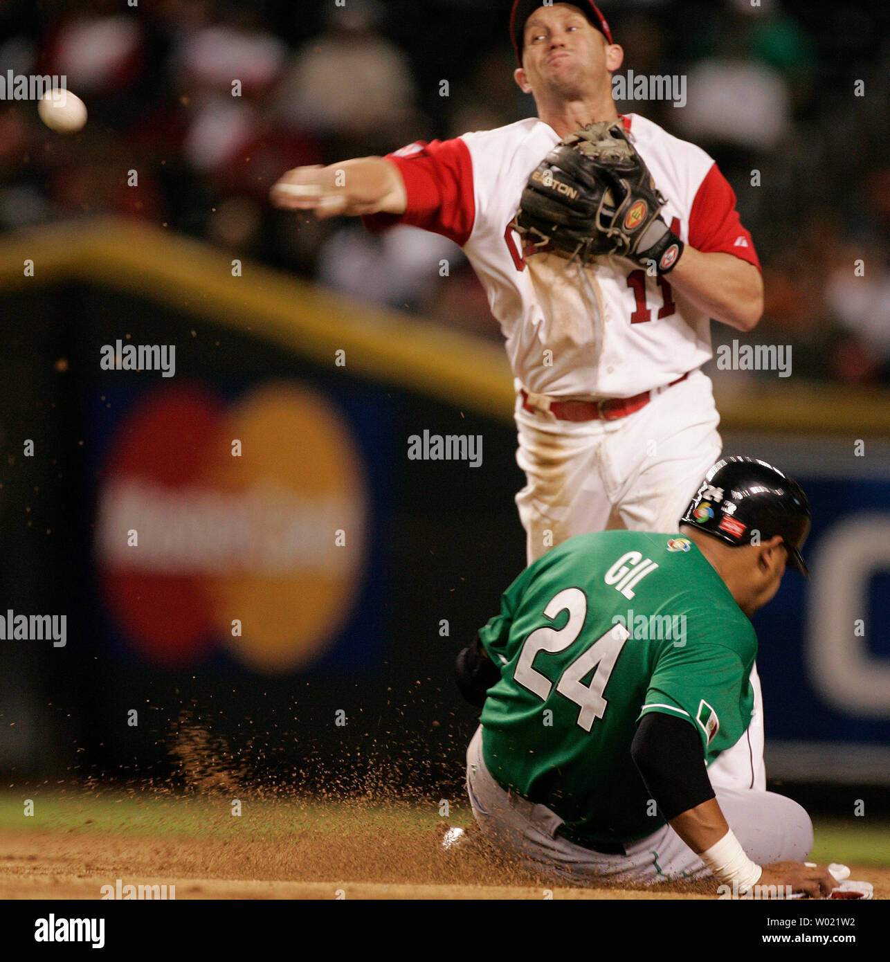 Team Canada Stubby Clapp turns a double play against Team Mexico's ...