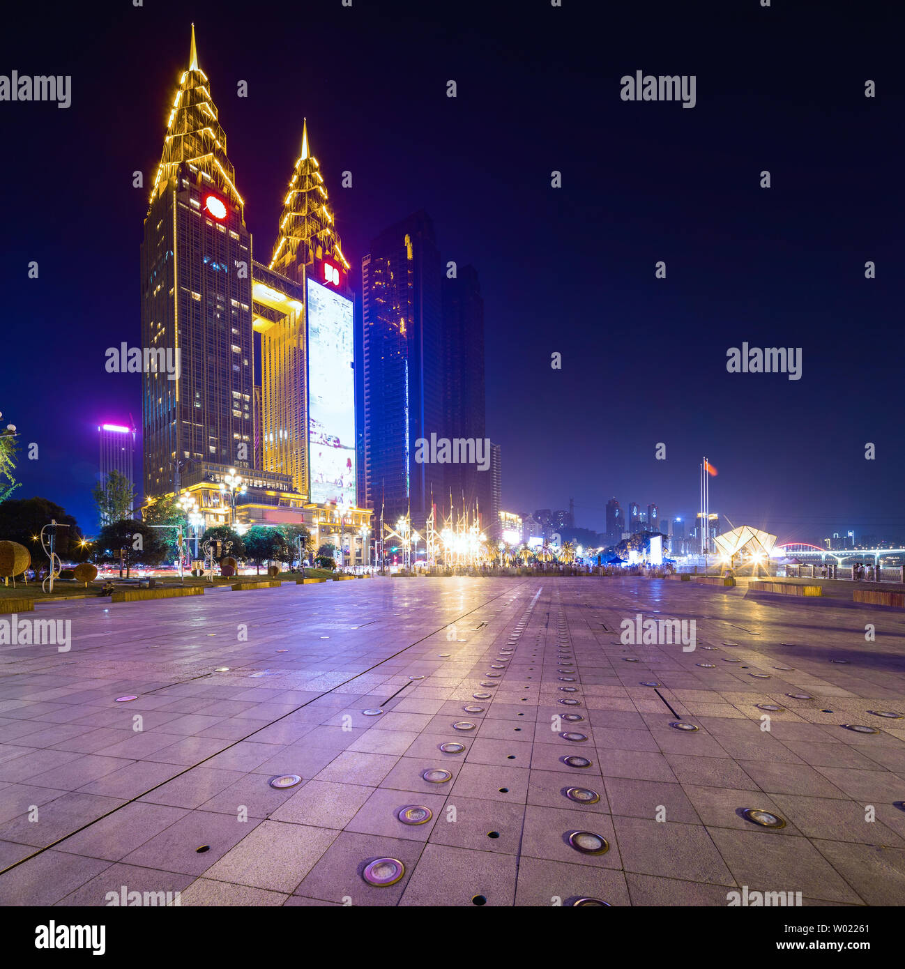 Empty floor and illuminated skyscraper Stock Photo - Alamy
