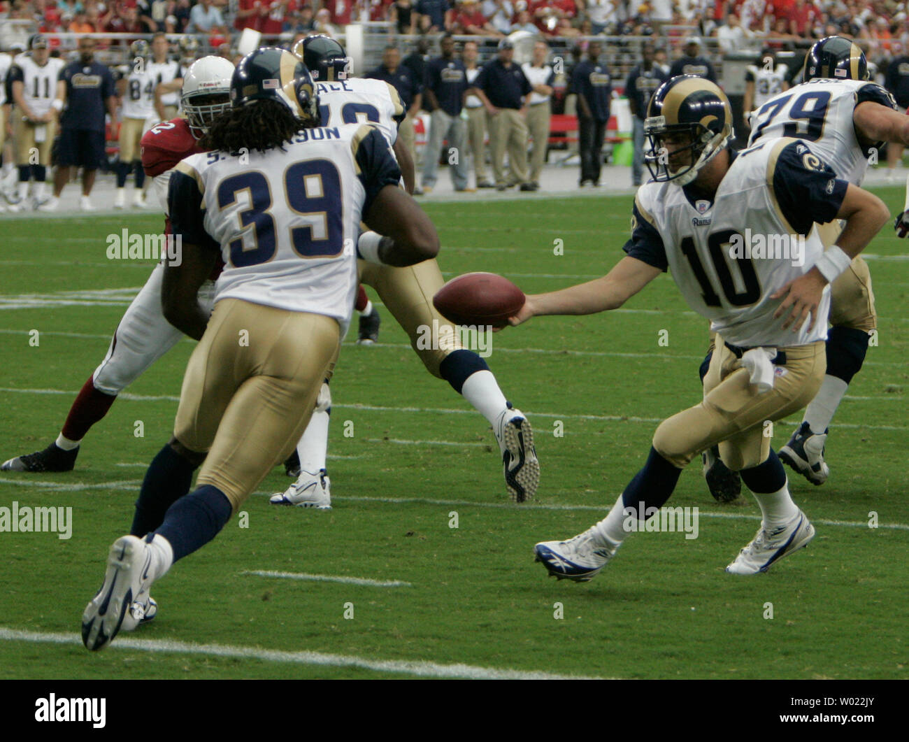 St. Louis Rams quarterback Marc Bulger hands off to Stephen Jackson ...