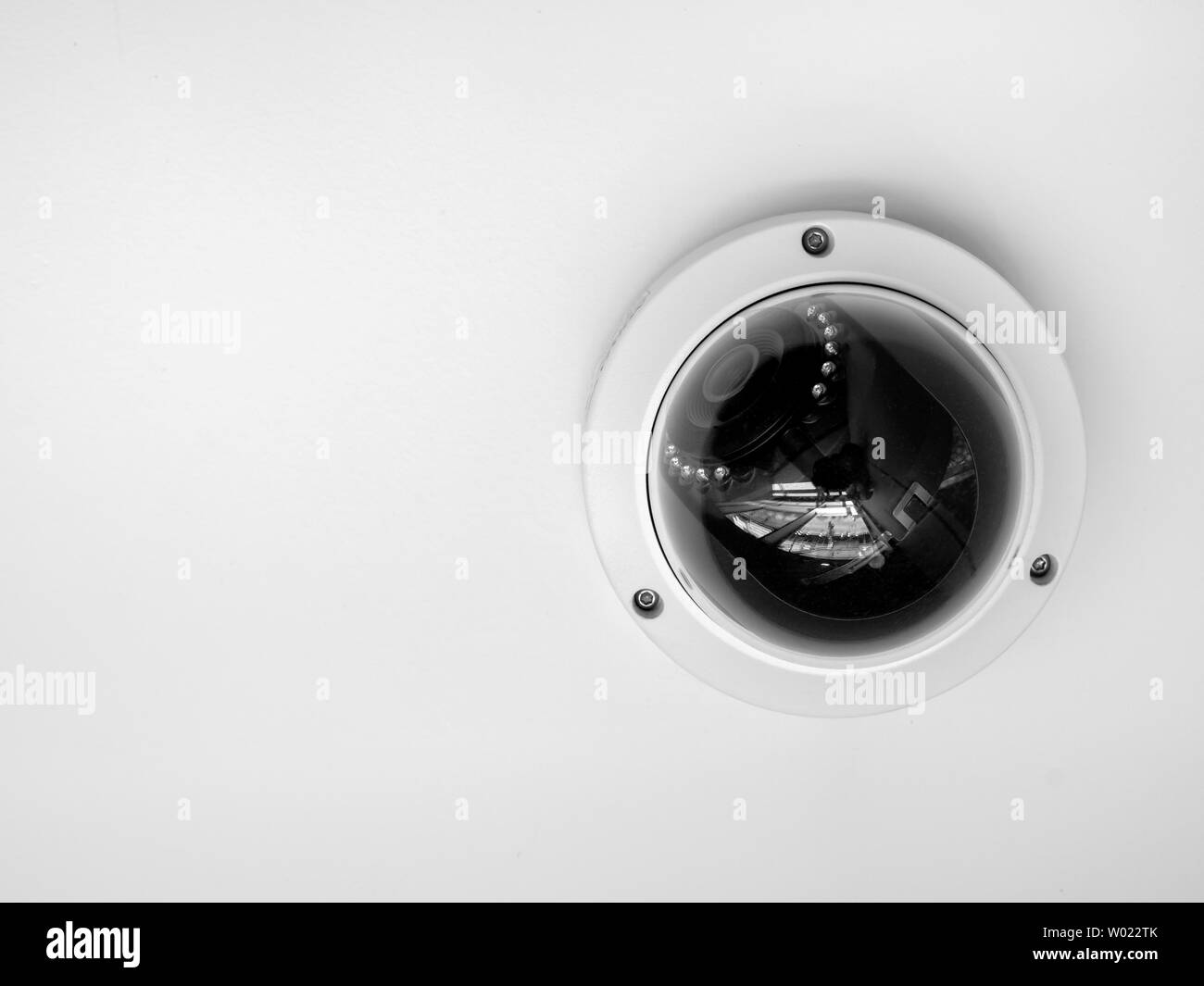 CCTV system security. Close-up round CCTV camera on ceiling isolated on ...