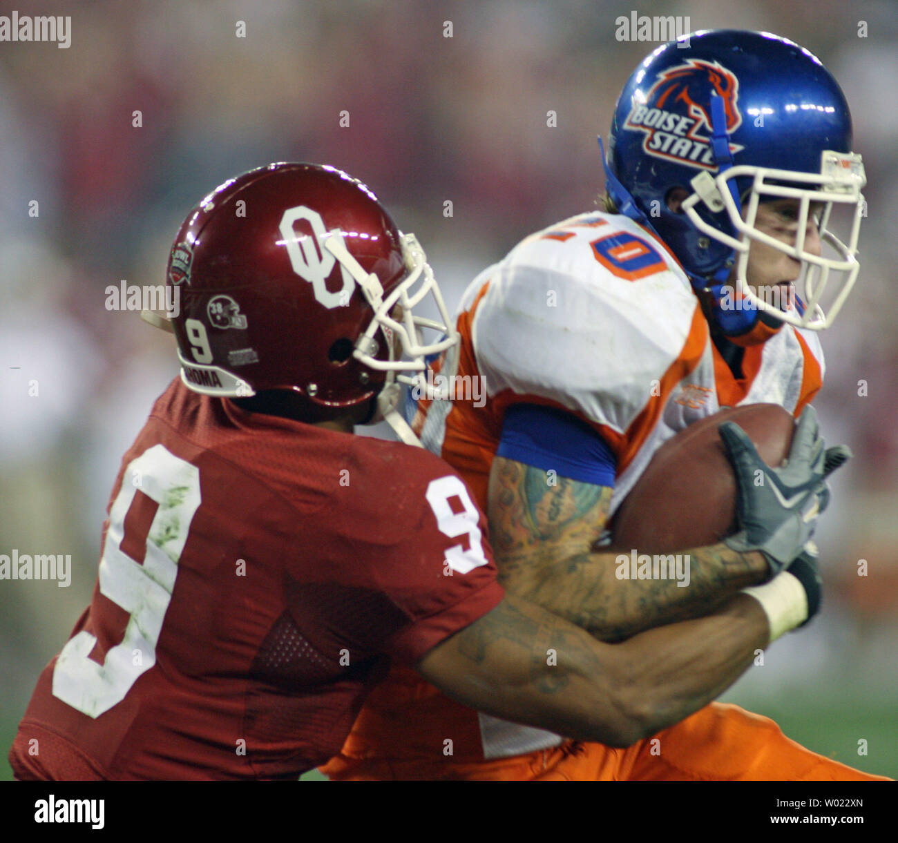 Boise State safety Marty Tadman (20) clutches the ball after ...