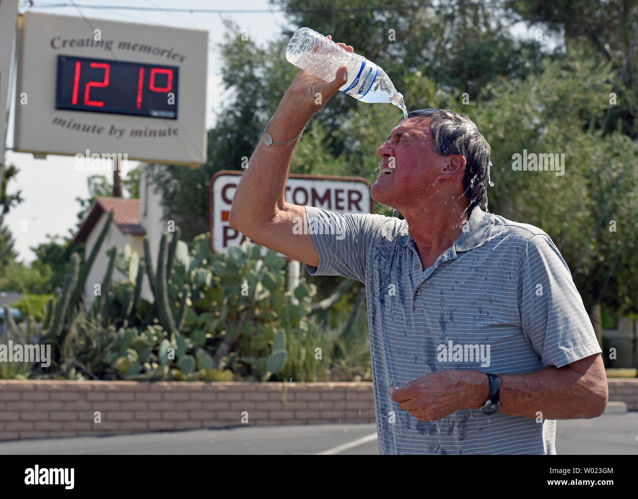 John Rinehart uses some of his drinking water to try and cool off in ...