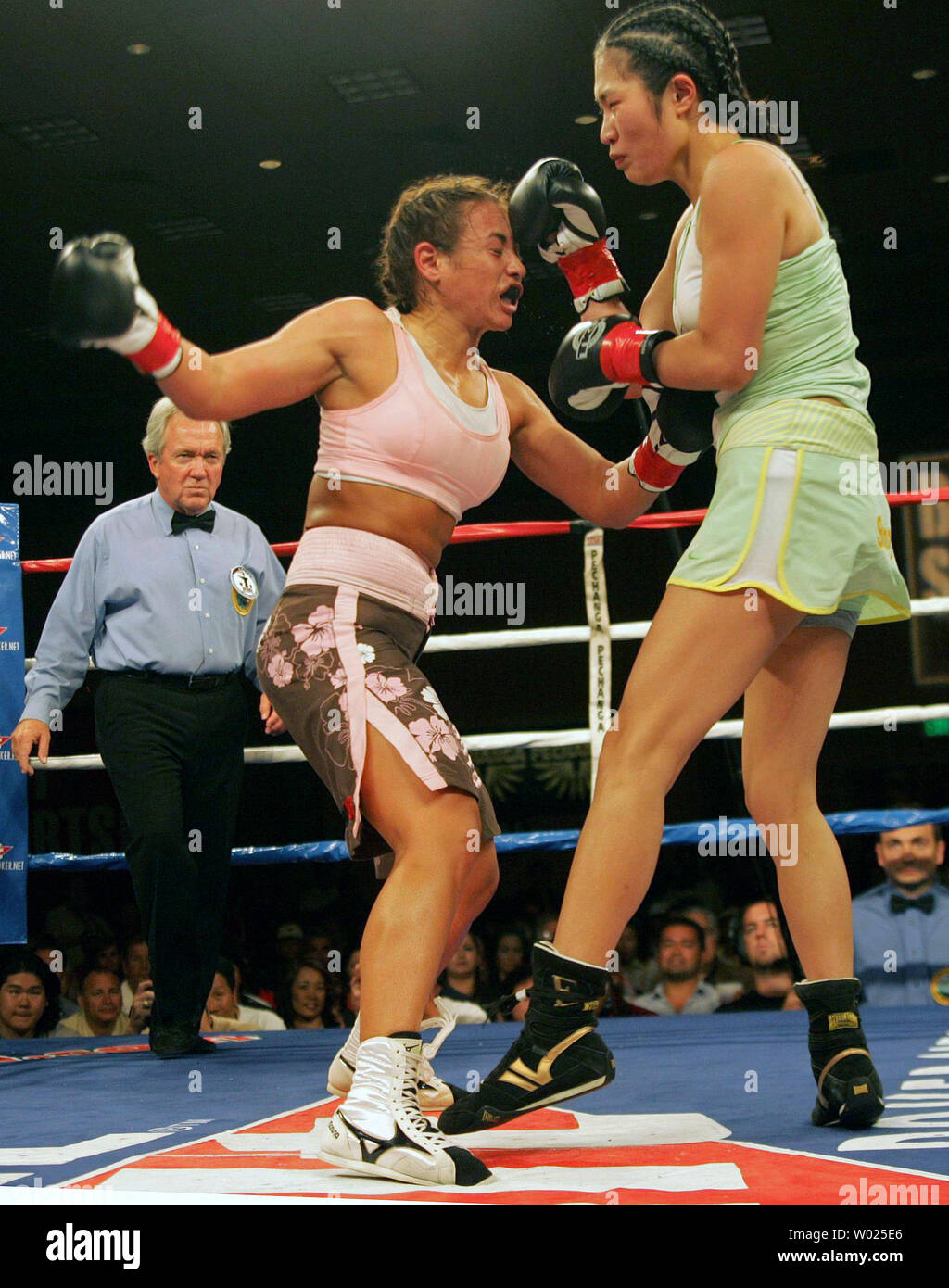 Challenger Elena "Baby Doll Reid" of Las Vegas lifts champion Shin Hee ...