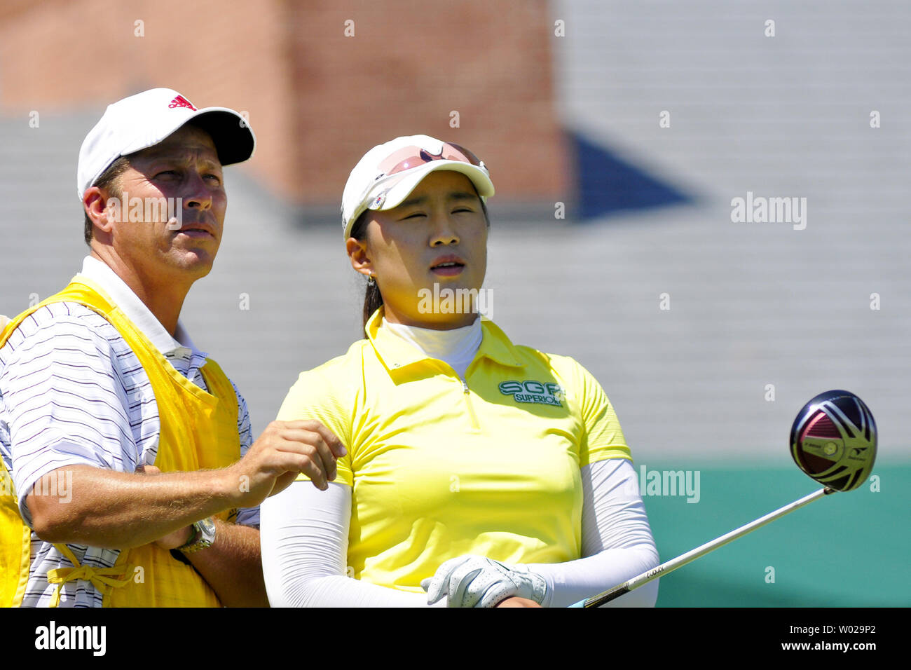 Amy Yang of Korea confers with her caddy before driving off the first ...