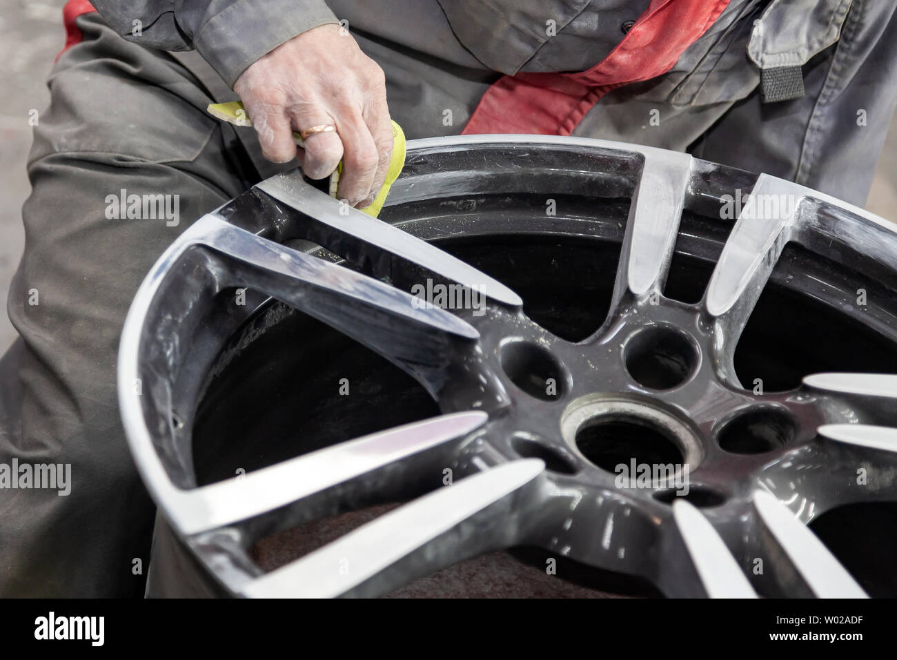 Master body repair man is working on preparing the surface of the ...