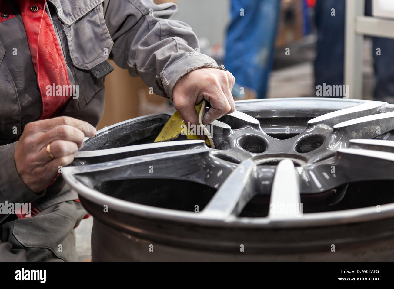 Master body repair man is working on preparing the surface of the ...