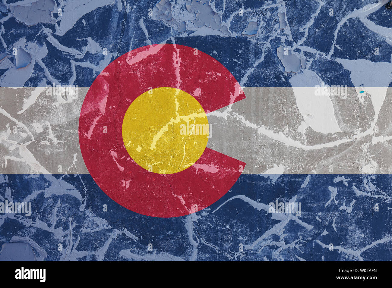 The national flag of the US state Colorado in against a gray wall with ...