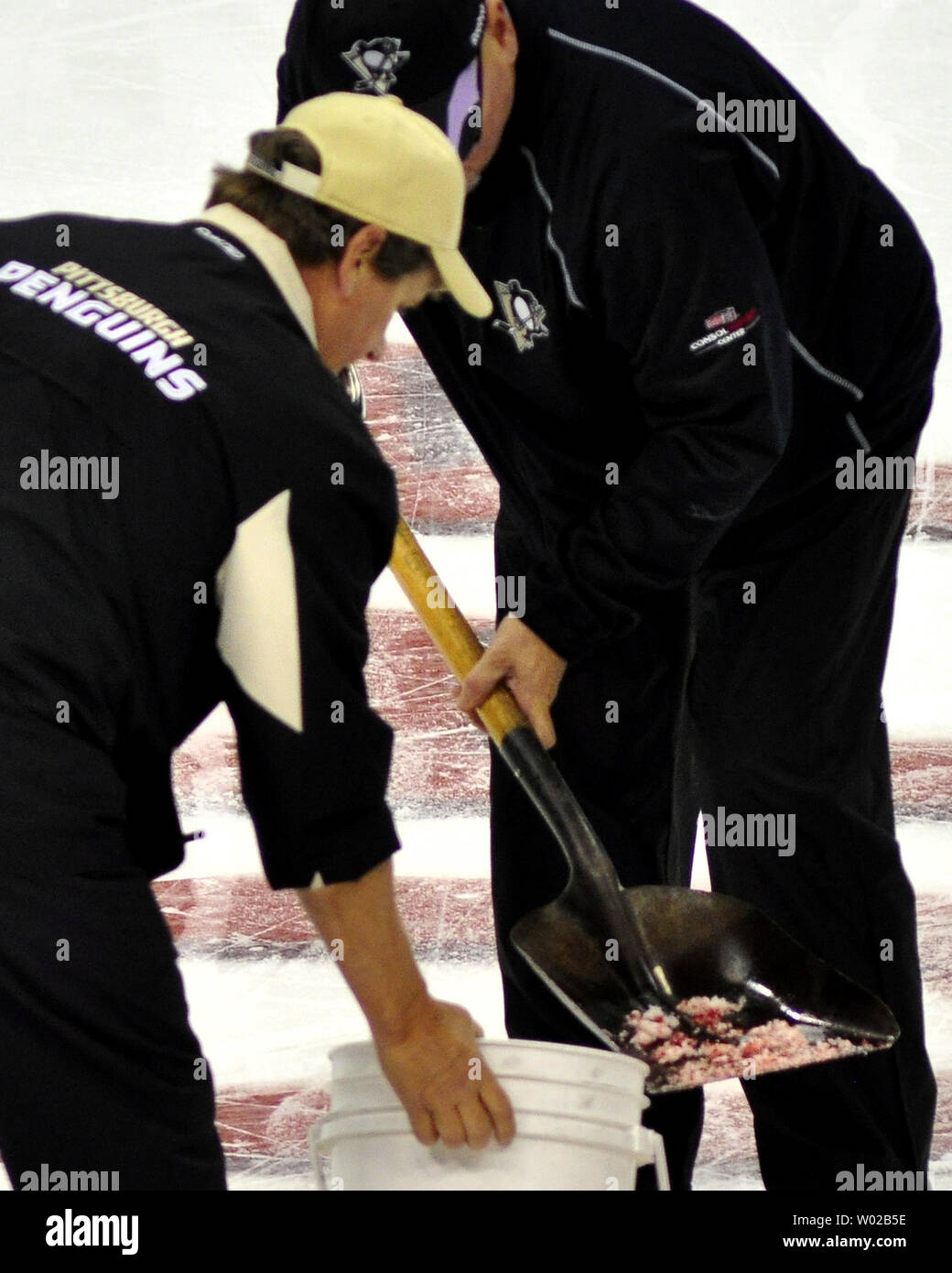 The Penguins ice crew clears the blood from the ice following the fight ...