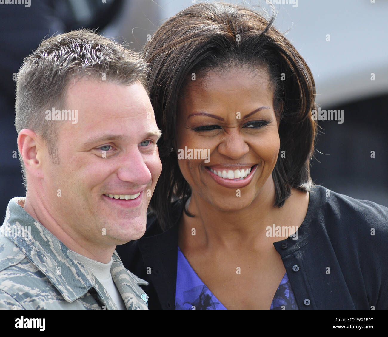 First Lady Michelle Obama poses for a photo with one of the several ...