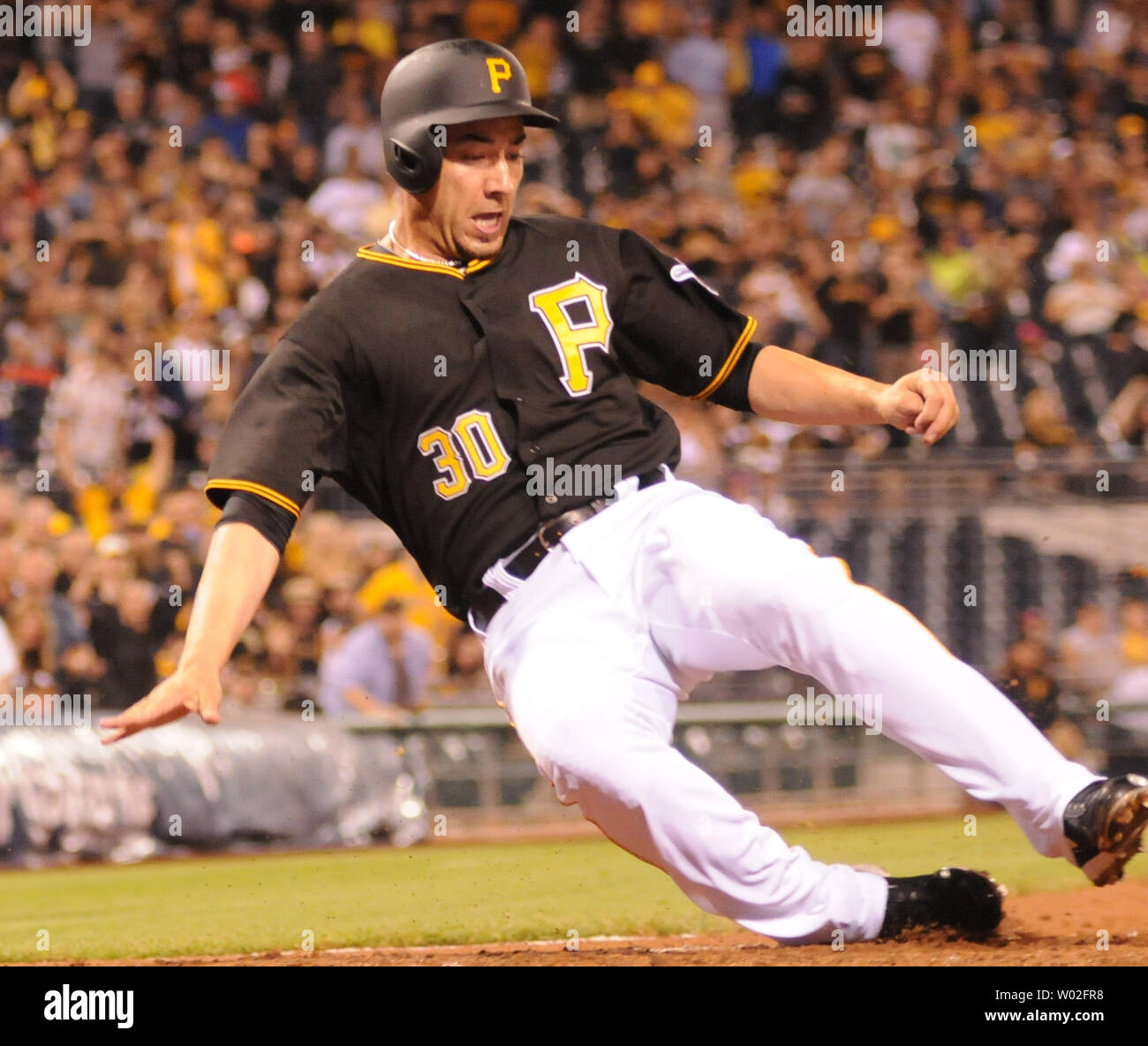 Pittsburgh Pirates first baseman Travis Ishikawa (30) slides into home ...