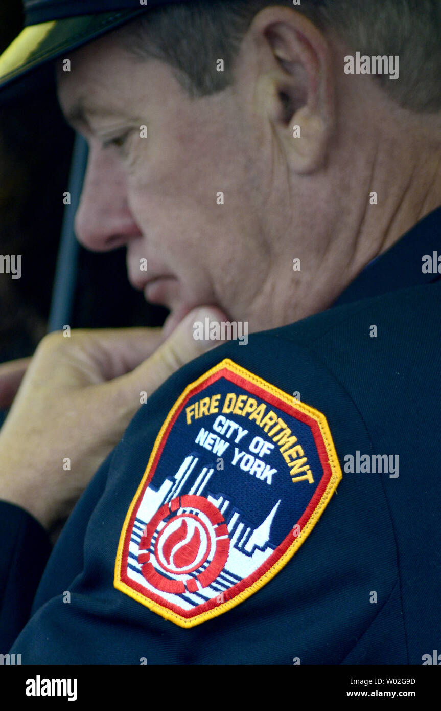 An invited guest from the City of New York Fire Department listens to ...