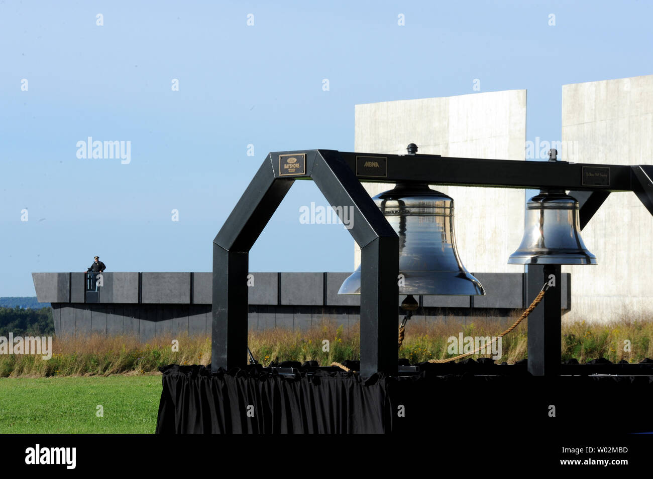 The Bell of Remembrance stand ready as an officer stands guard at the ...