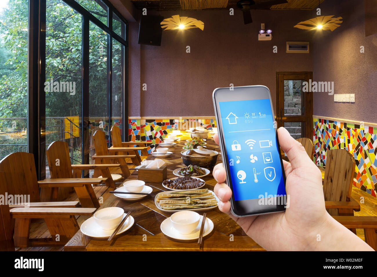 smart phone with smart home and modern restaurant in hotel Stock Photo ...