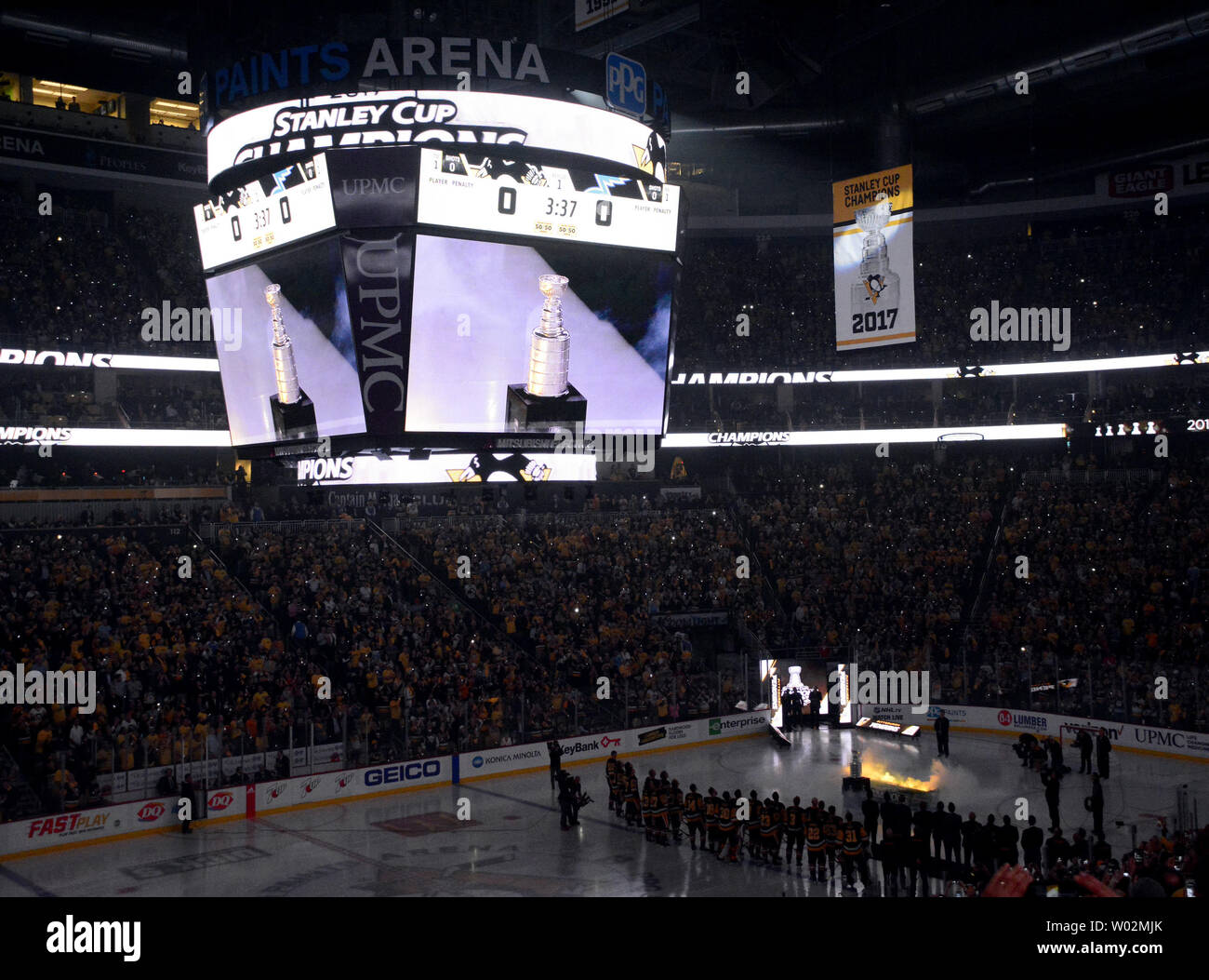Pittsburgh Penguins fans and player watch as the banner raises to the ...