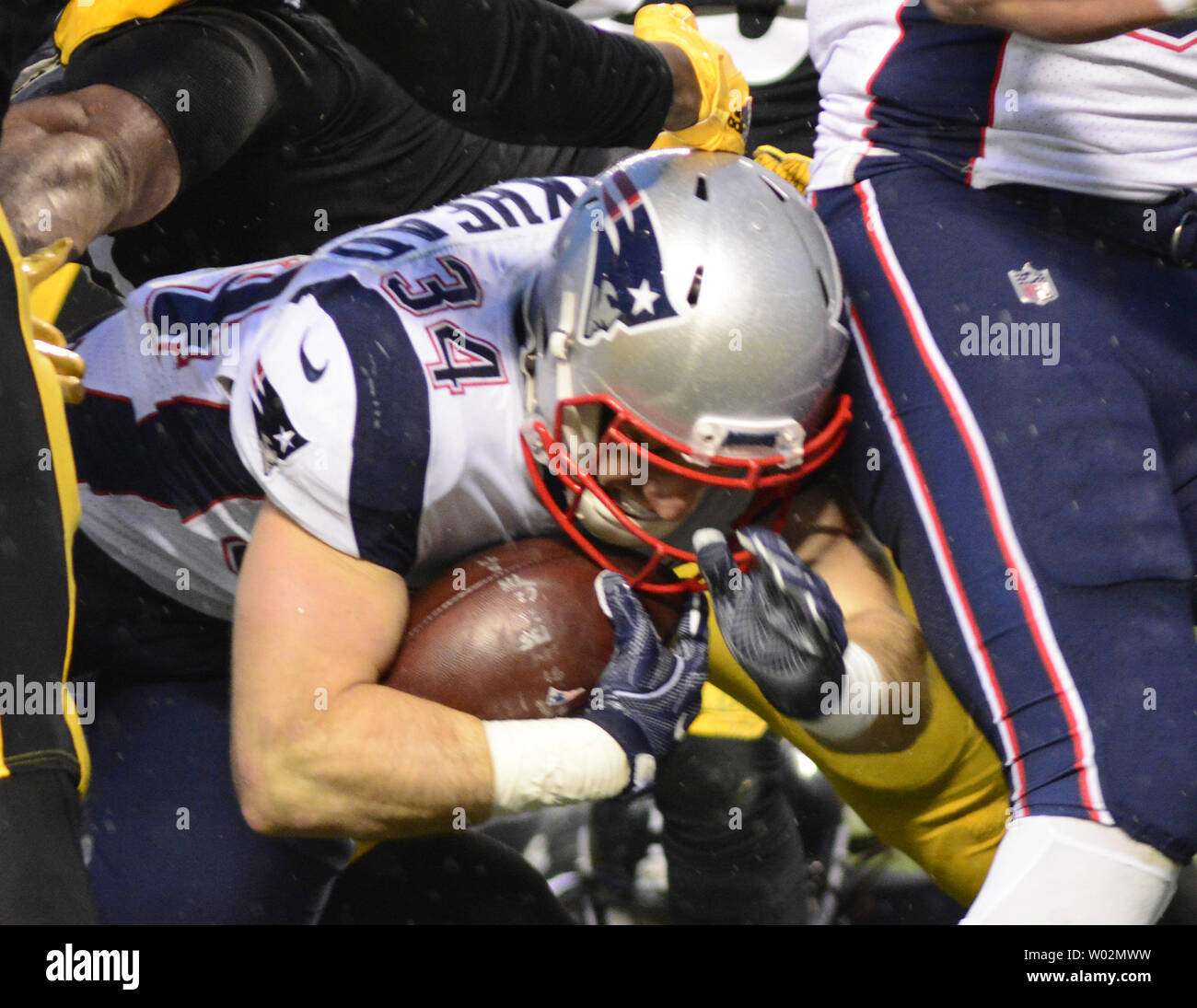 New England Patriots running back Rex Burkhead (34) muscles his way ...