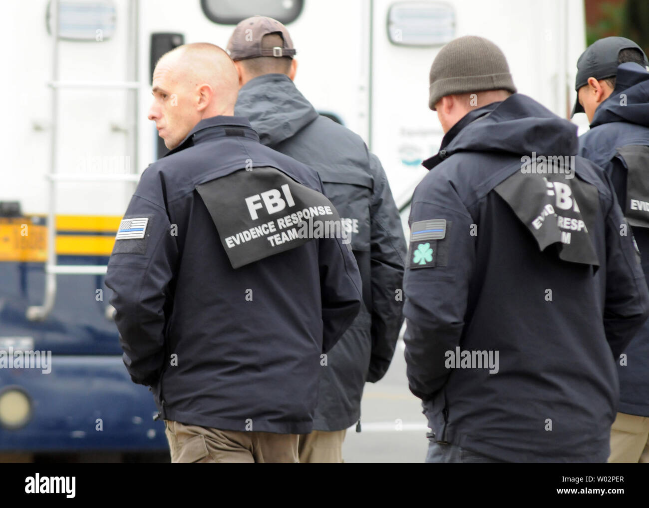 FBI investigators walk by the temporary memorial at the Tree of Life ...