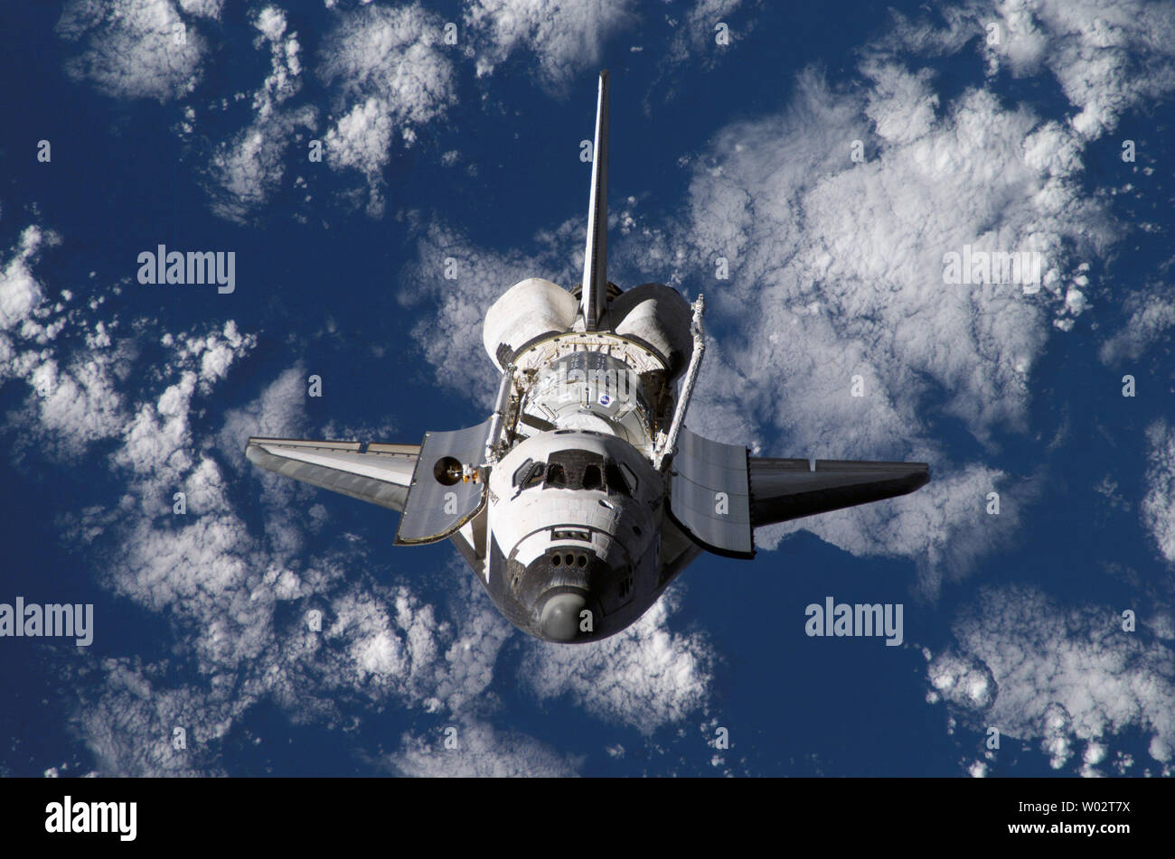 Backdropped by part of Earth, Space Shuttle Discovery (STS-120 ...