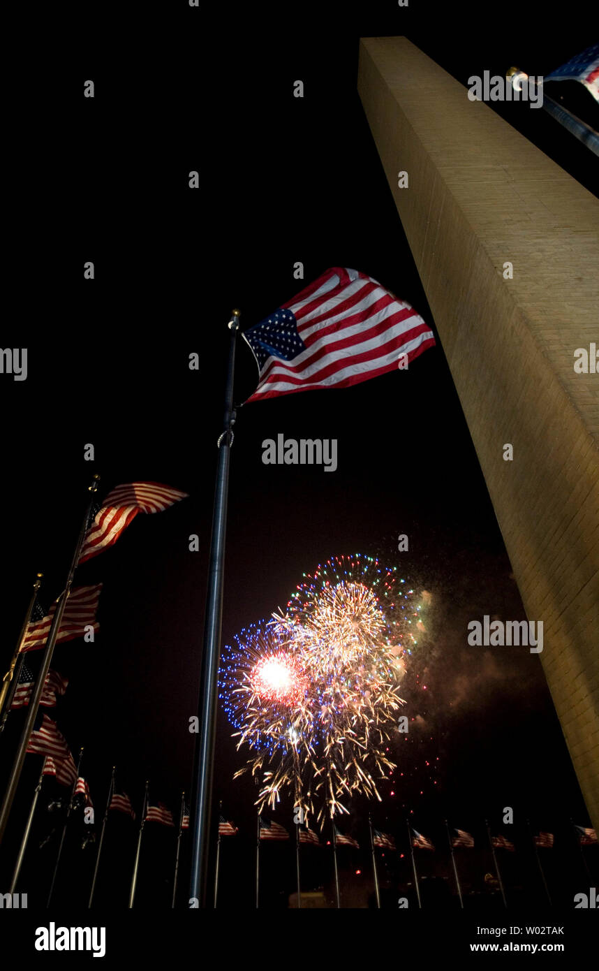 Flags wave in the breeze as the Fourth of July fireworks display begins ...