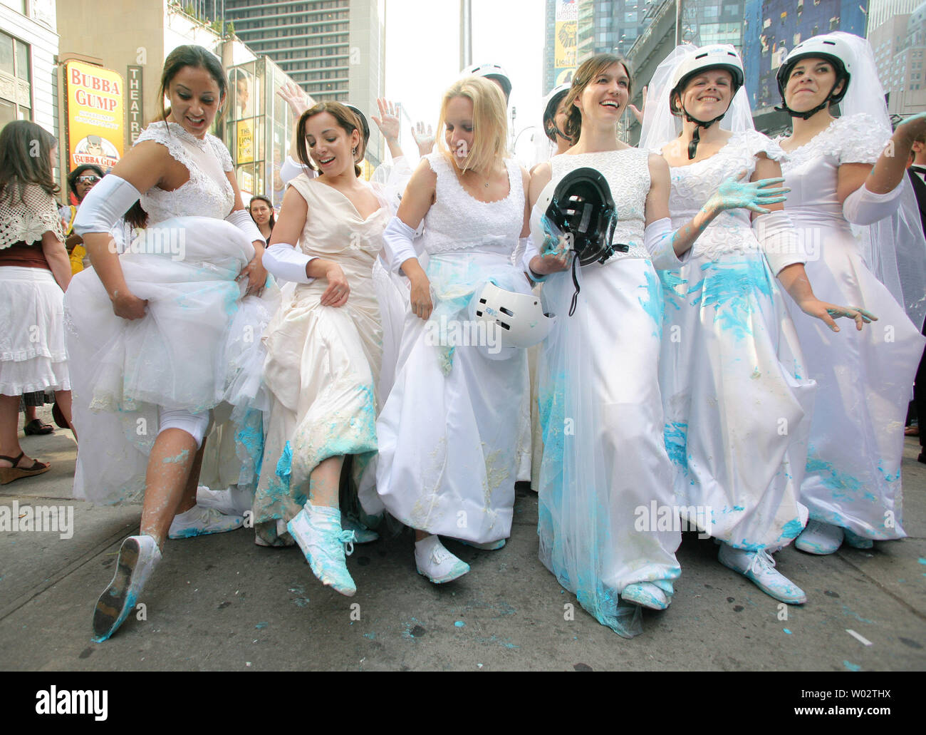 Brides show off the blue frosting that got smeared onto their gowns ...