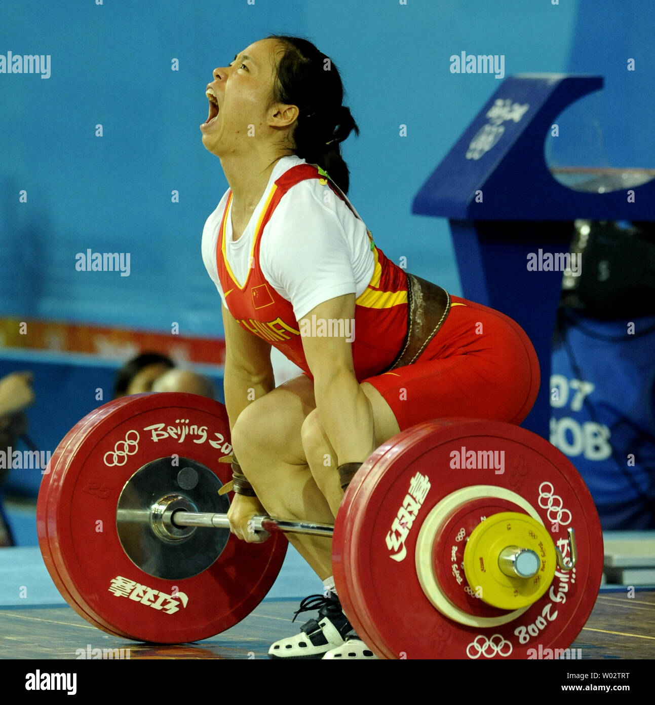 Chinese weight lifter Chen Yanqing begins her lift of 138 KG to set a ...