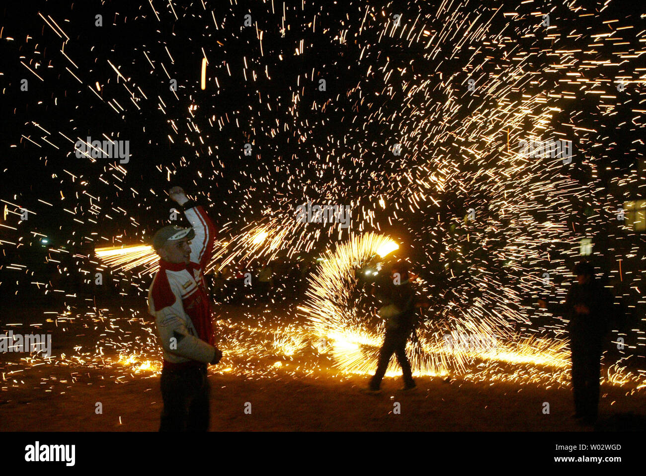 Iranian Mehrdad, Hooman and Davoud play with fire during a ceremony ...