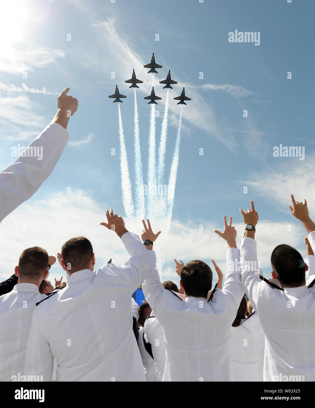 Graduating Midshipmen cheer as the Navy Blue Angels fly over at the ...