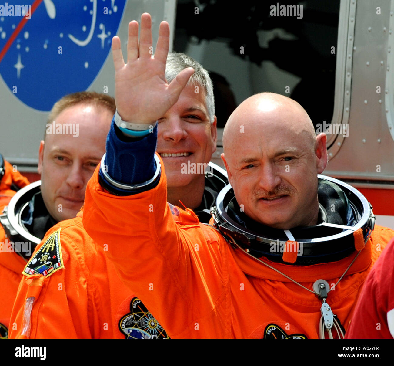 Space Shuttle Endeavour Commander Mark Kelly (right) waves after ...