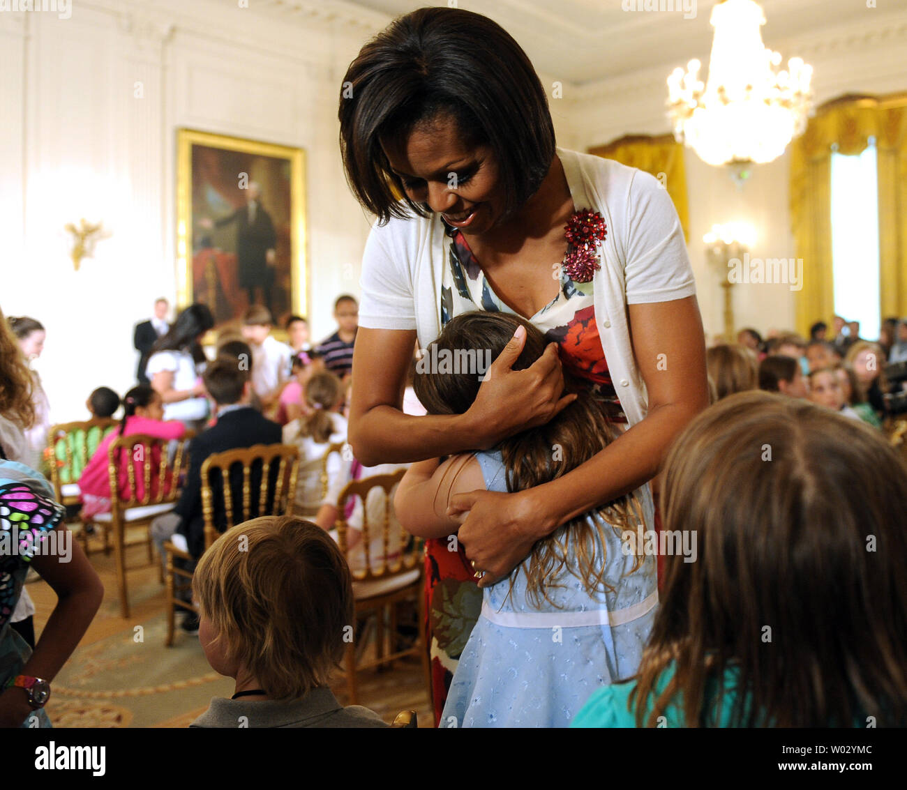 First Lady Michelle Obama hugs children of Executive Office employees ...
