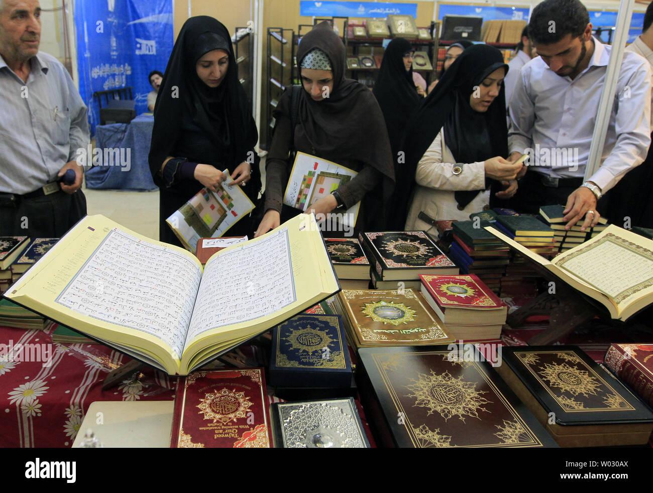 Iranians shop for Qurans during the International Quran Exhibition at ...