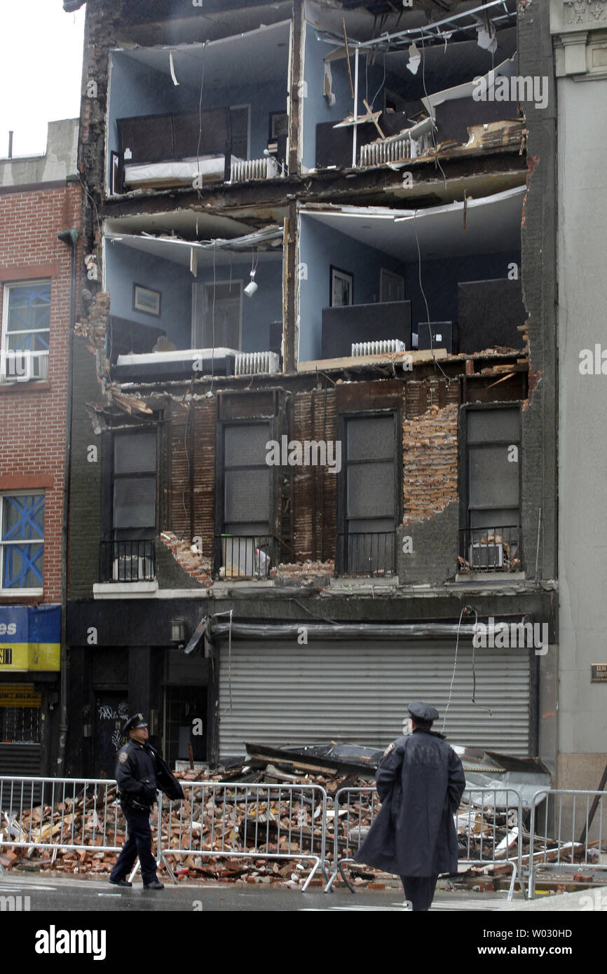 An apartment building in Chelsea stands with its front completely torn ...