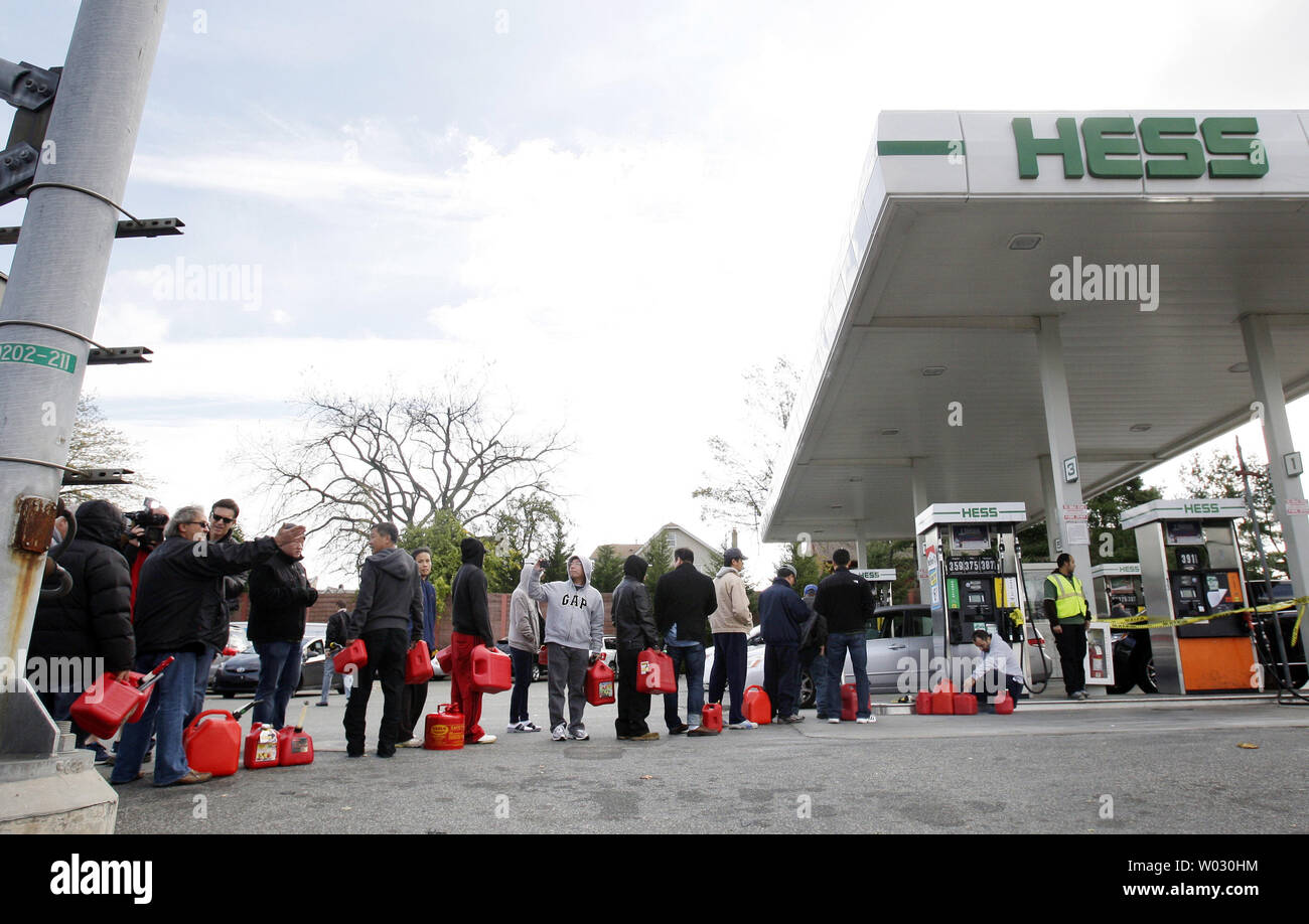 People line up at a gas station with empty gas containers two days ...