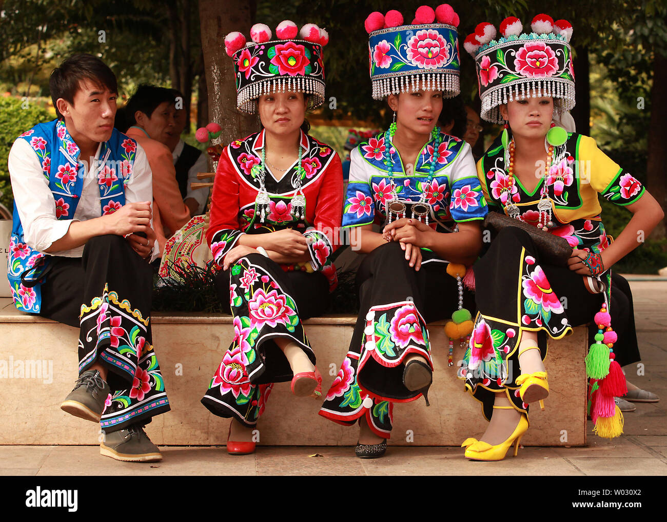 Chinese ethnic minorities wearing their traditional garb wait to dance ...