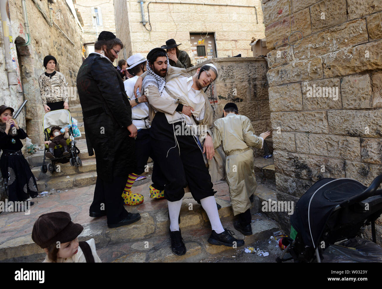 An Ultra-Orthodox Israeli helps a drunk man on the Jewish holiday of ...