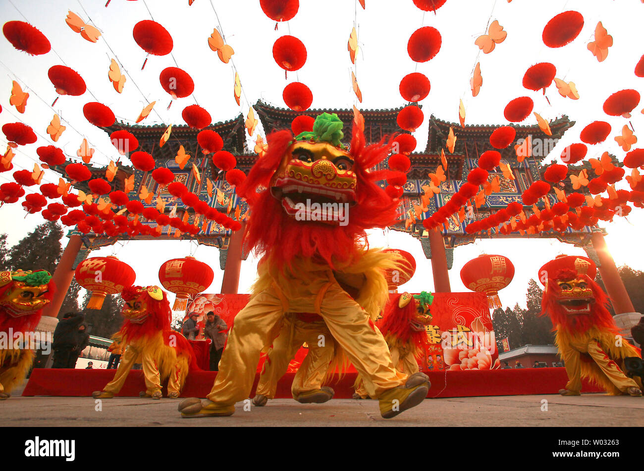 Chinese artists perform a traditional lion dance at the opening ...