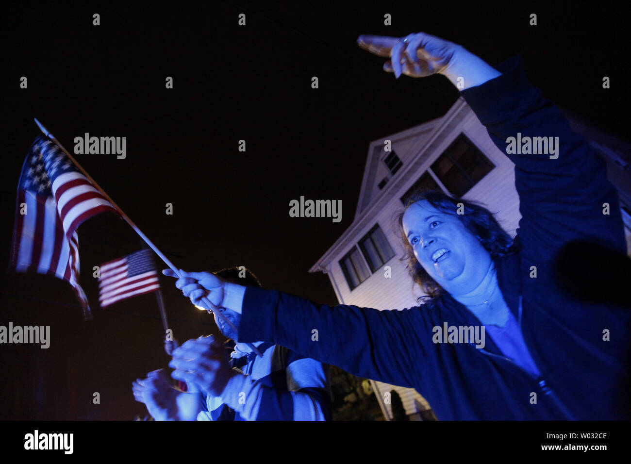 Barbara Faherty waves an American flag and cheers on the police with ...