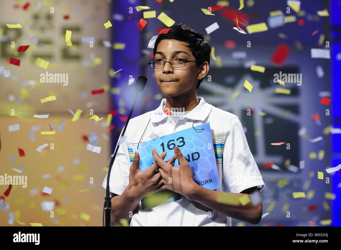 Arvind Mahankali, 13, of Bayside Hills, New York stands as confetti ...