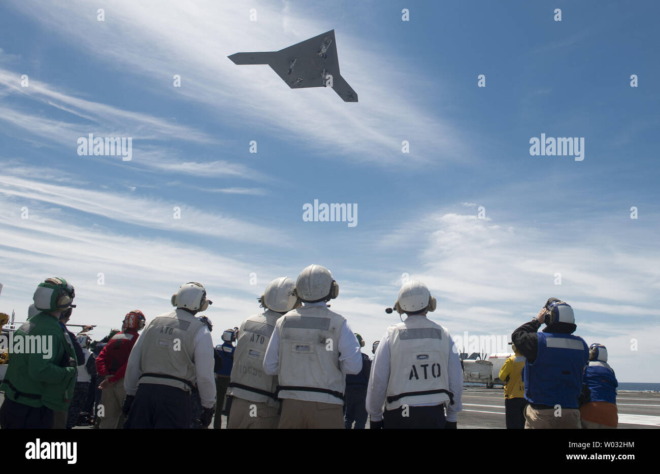 An X-47B Unmanned Combat Air System (UCAS) demonstrator flies over the ...