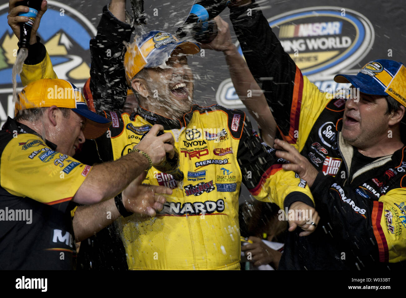 Racer Matt Crafton (88) celebrates with his crew after winning the 2013 ...