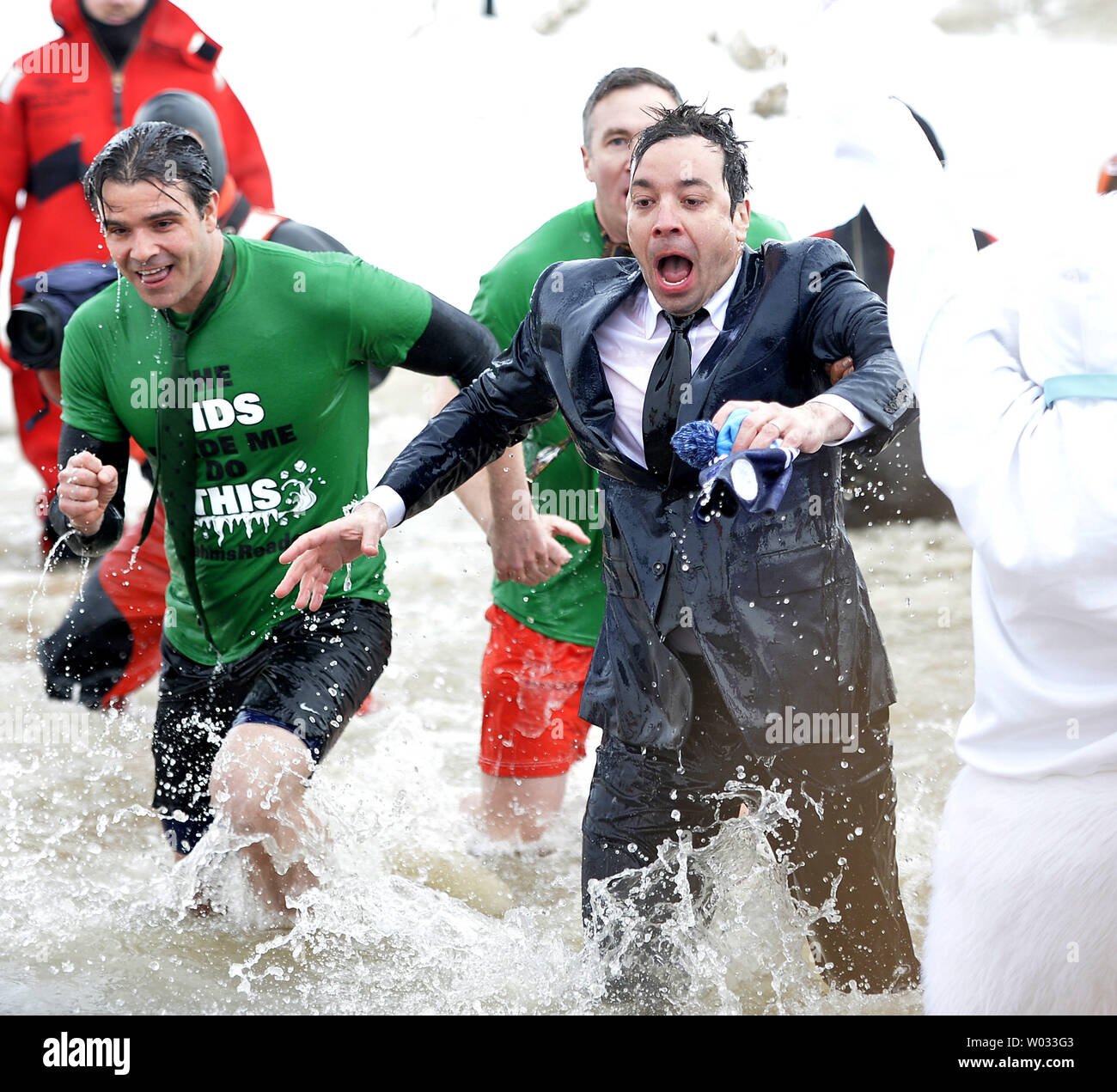 Tonight Show host Jimmy Fallon (R) emerges from Lake Michigan after ...