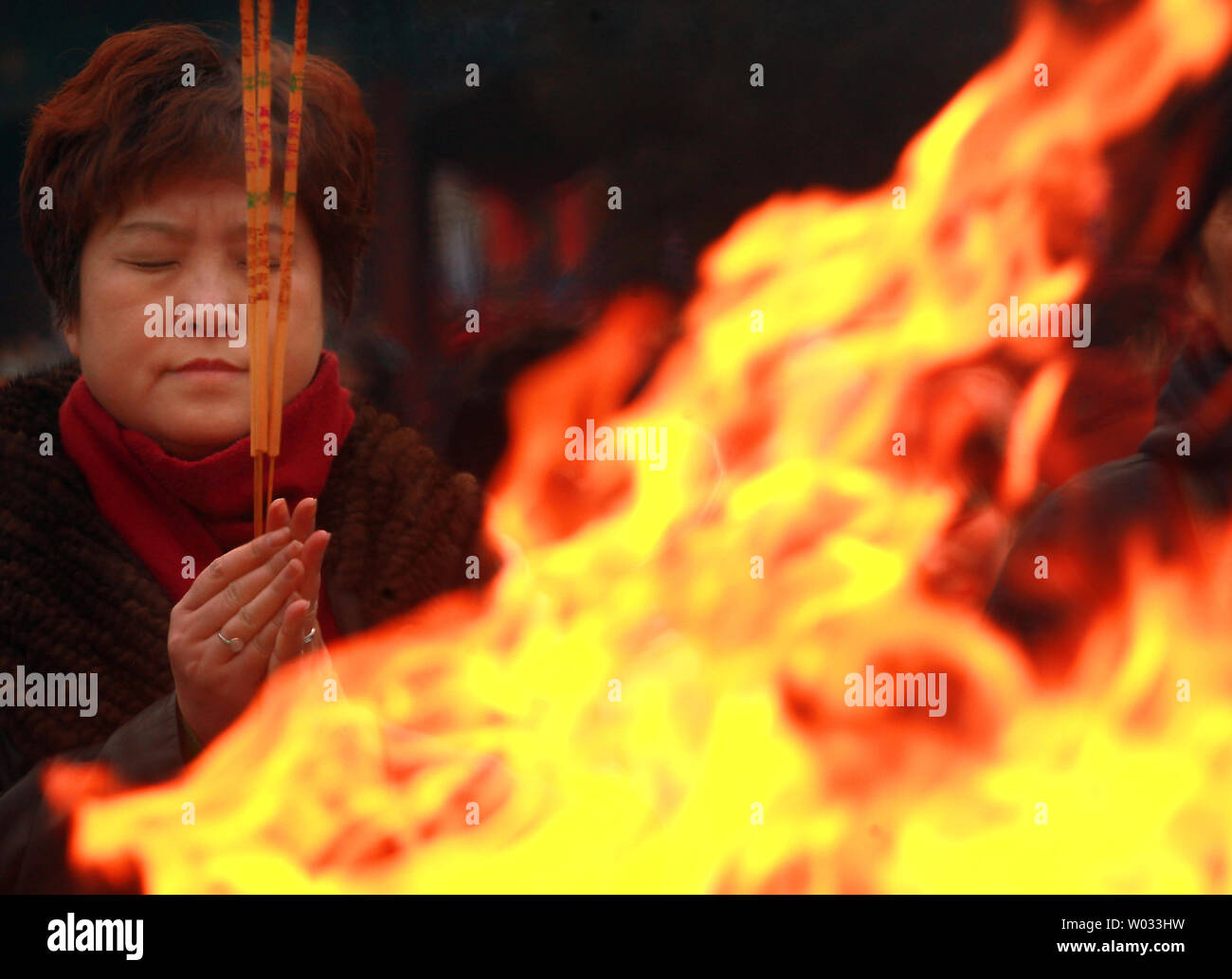 Chinese light incense sticks and pray at the Dongyue Taoist temple on ...